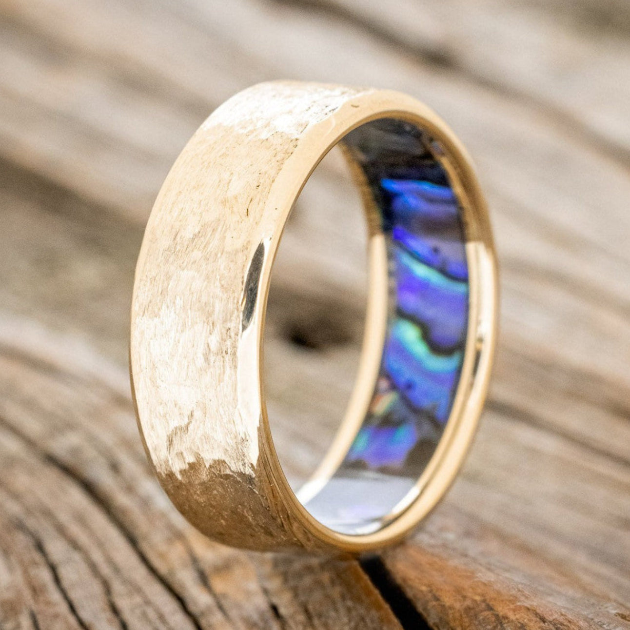 PAUA SHELL LINED WEDDING RING FEATURING A HAMMERED 14K GOLD BAND