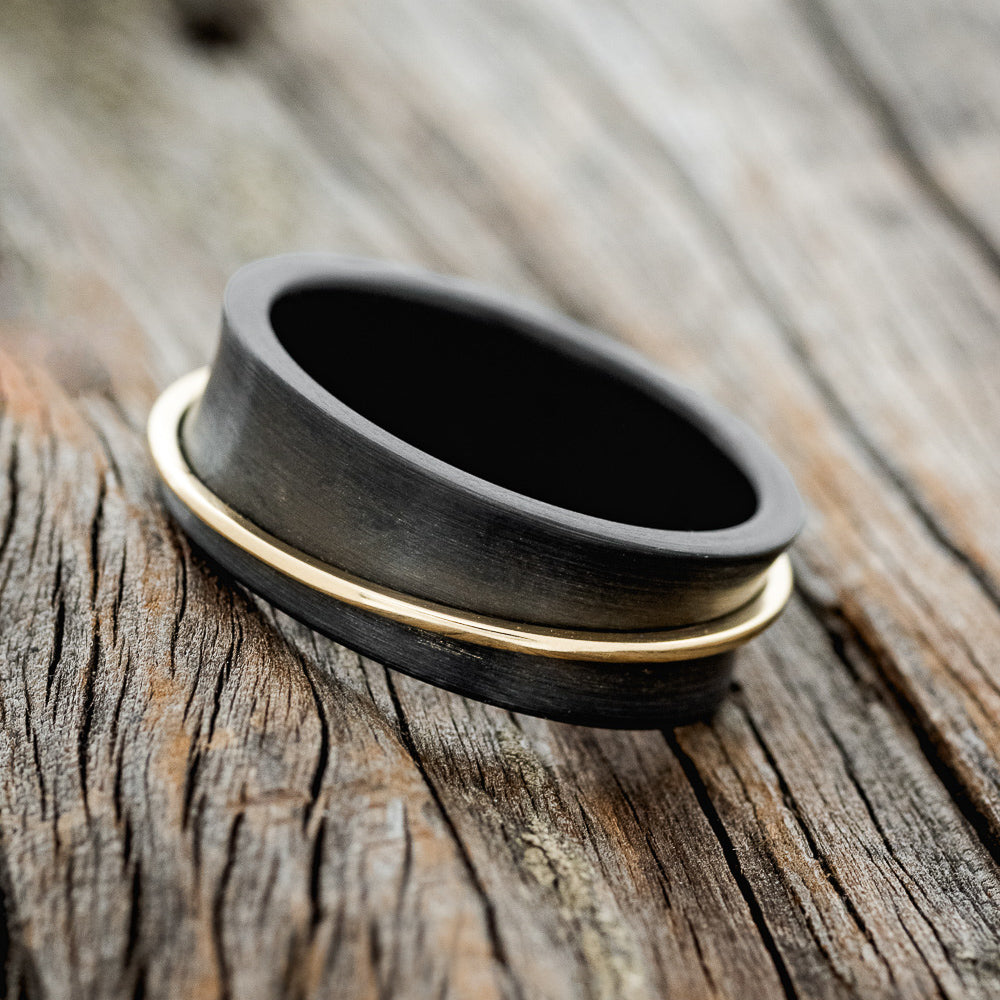 "ROTARY" - 14K GOLD SPINNER WEDDING RING FEATURING A CONCAVE BLACK ZIR